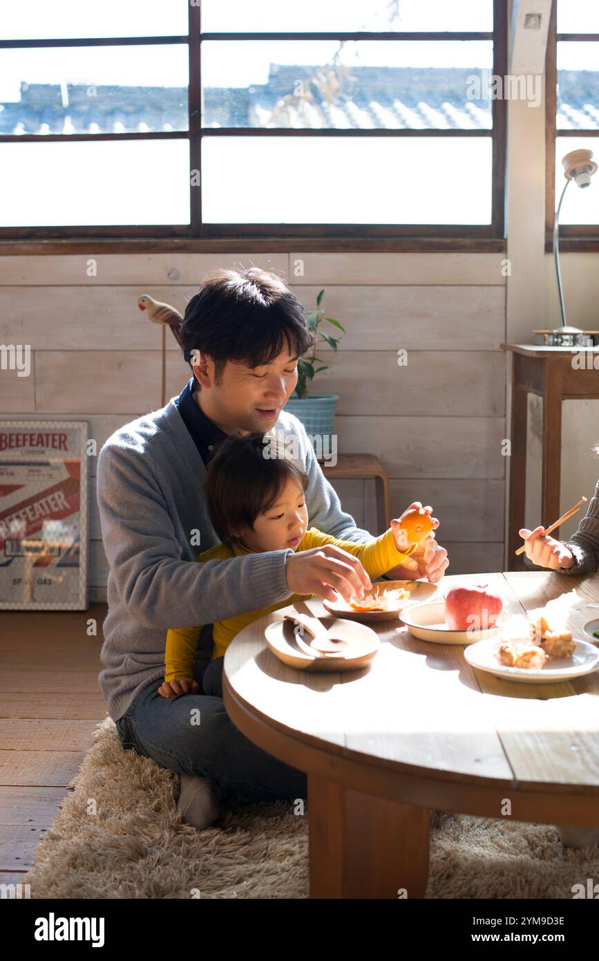 Family eating rice Stock Photo - Alamy