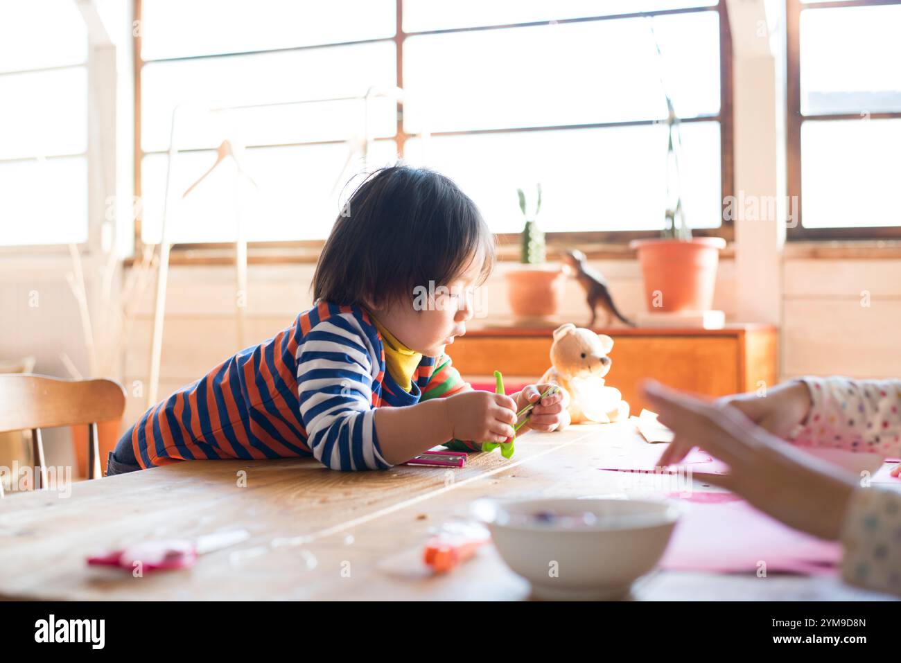 Children playing at table Stock Photo - Alamy