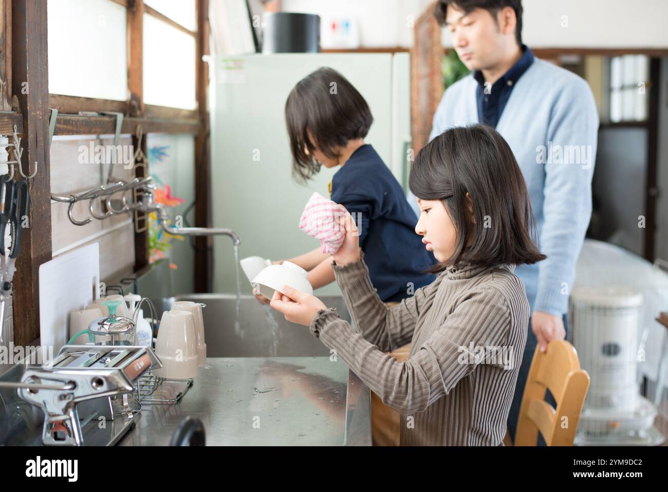 Children doing water work in the kitchen Stock Photo - Alamy