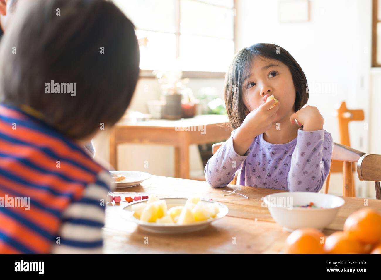 Child eating fruit Stock Photo - Alamy