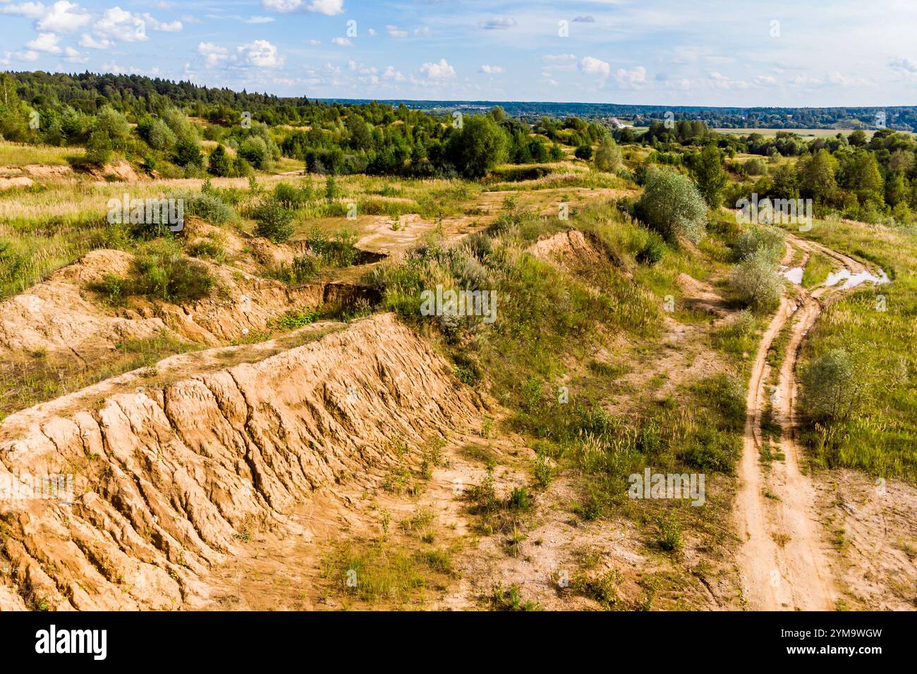 Top view of an old inactive sand quarry overgrown with greenery, a dug ...