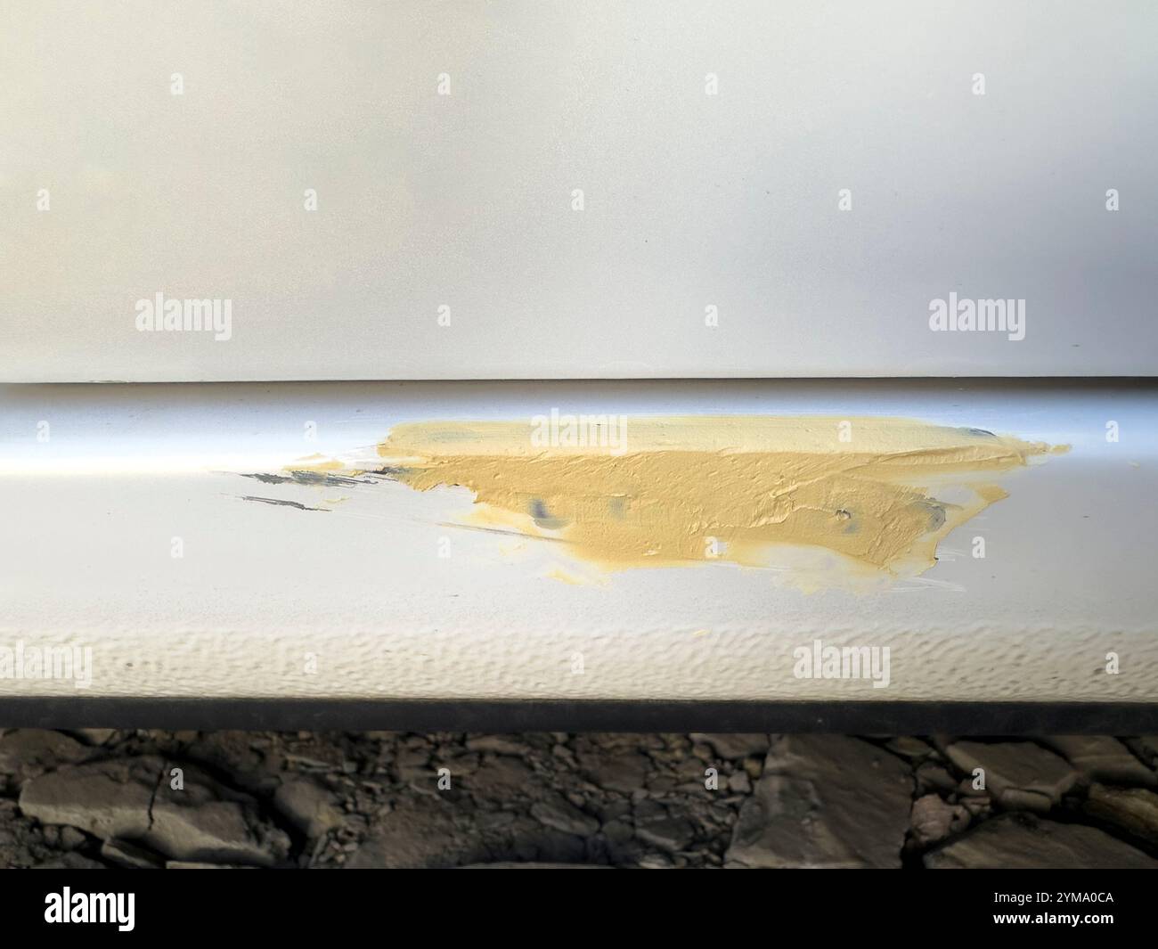 Car bodywork in progress with filler applied over damage. Prepare ...