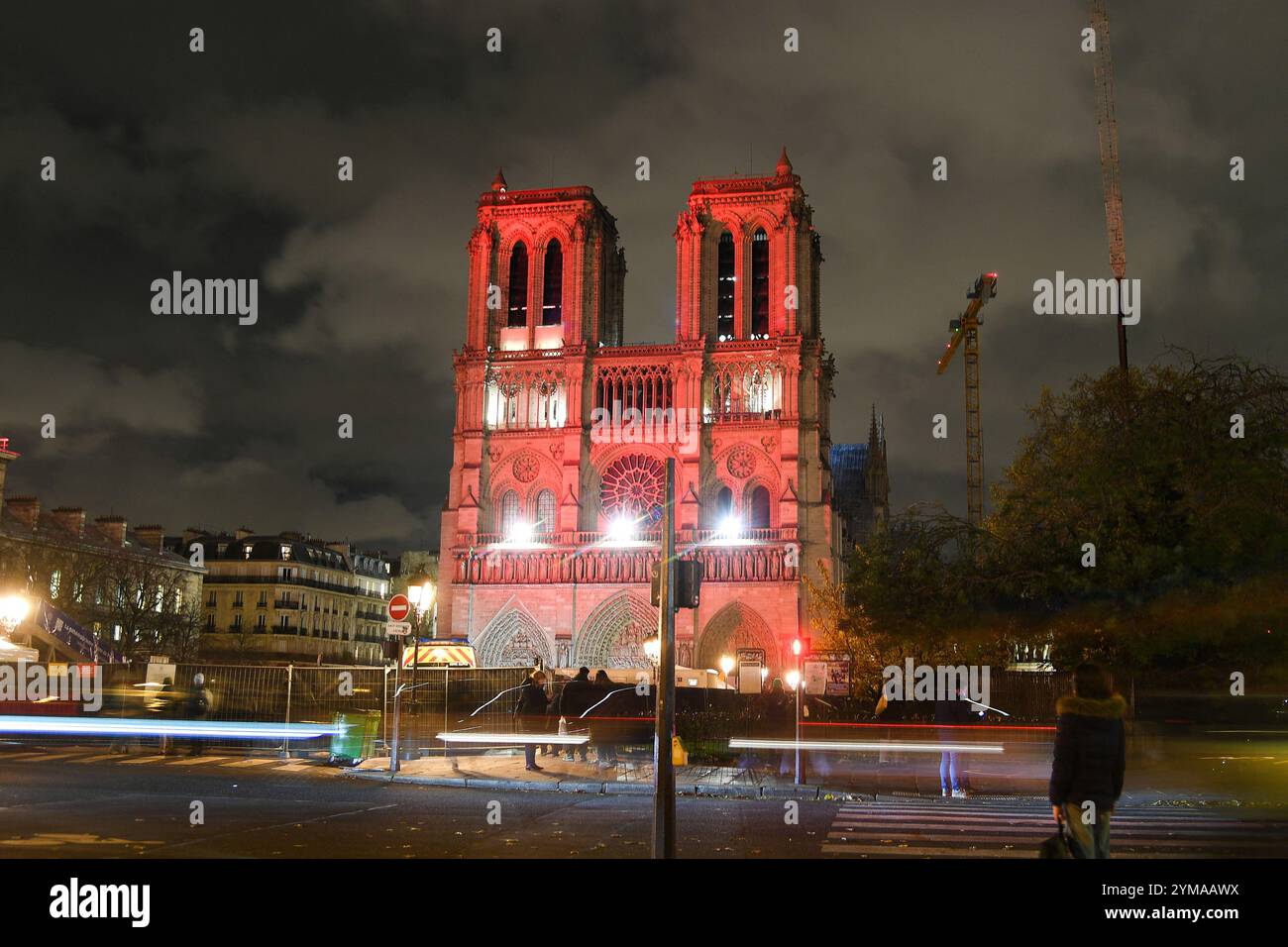 Paris, France. 20th Nov, 2024. Notre-Dame cathedral illuminated in red ...
