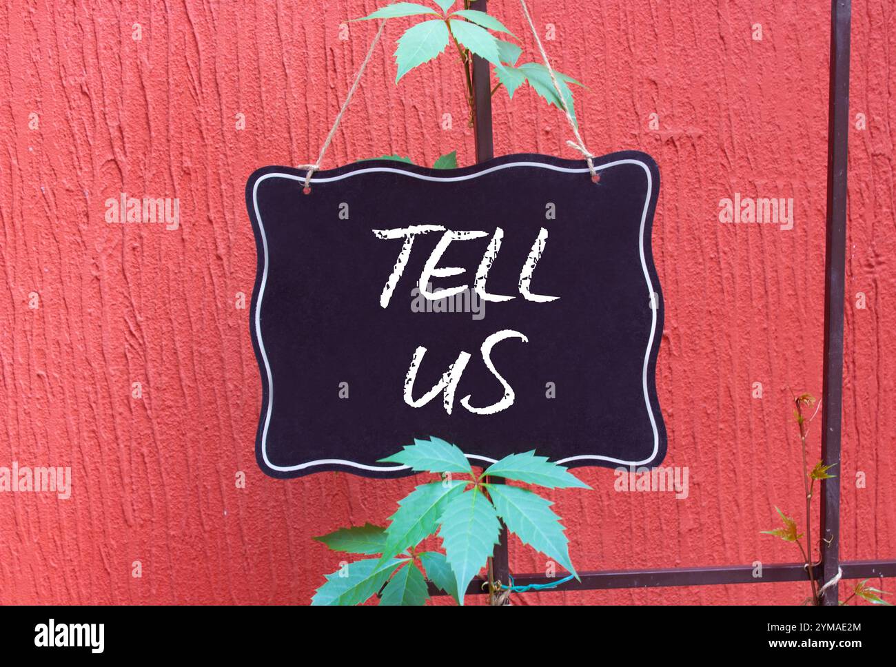 Tell us symbol. Concept words Tell us on black chalk blackboard ...