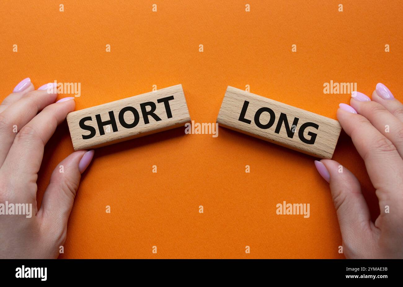 Short vs Long symbol. Concept word Short vs Long on wooden blocks ...