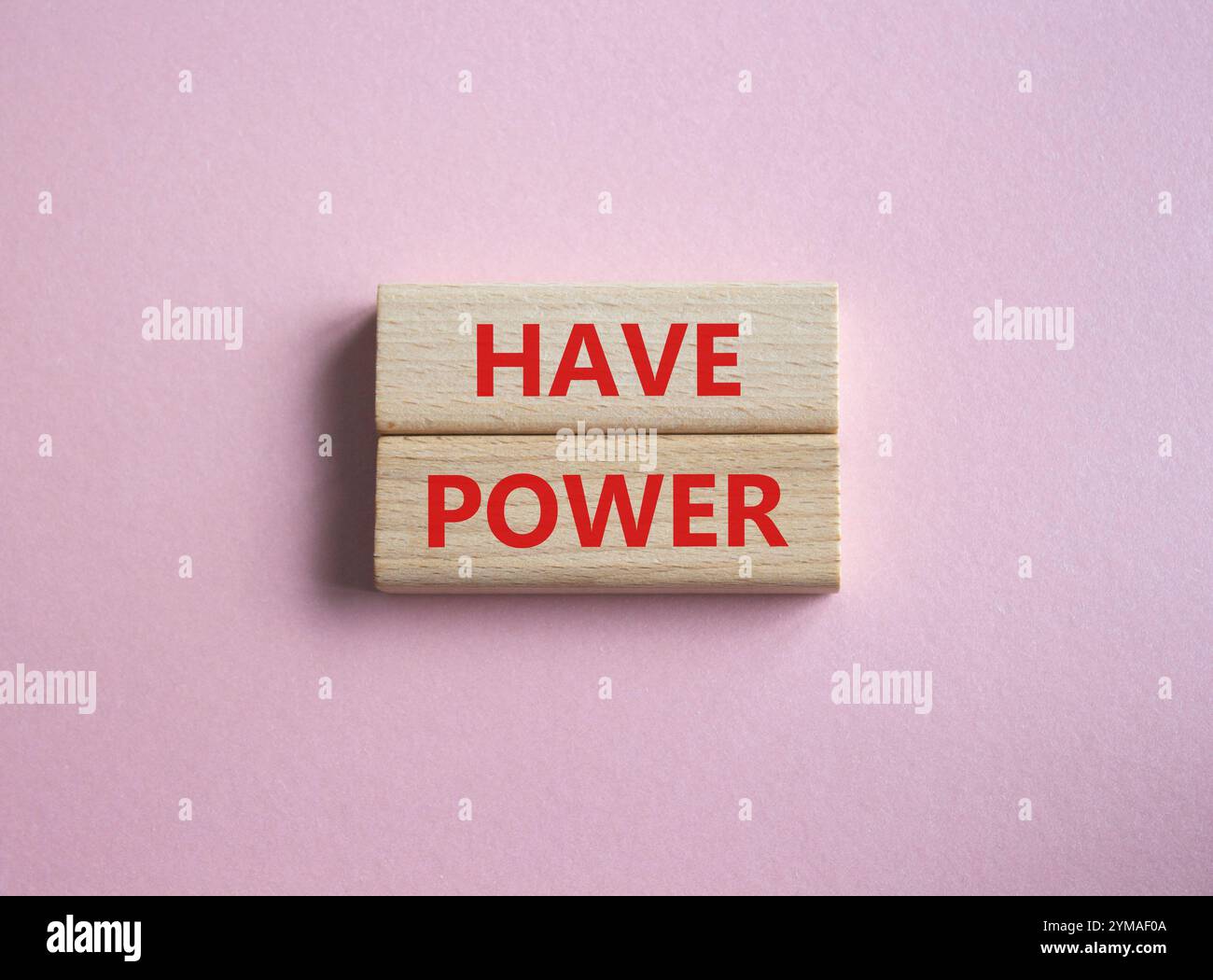 Have power symbol. Wooden blocks with words have power. Beautiful pink ...