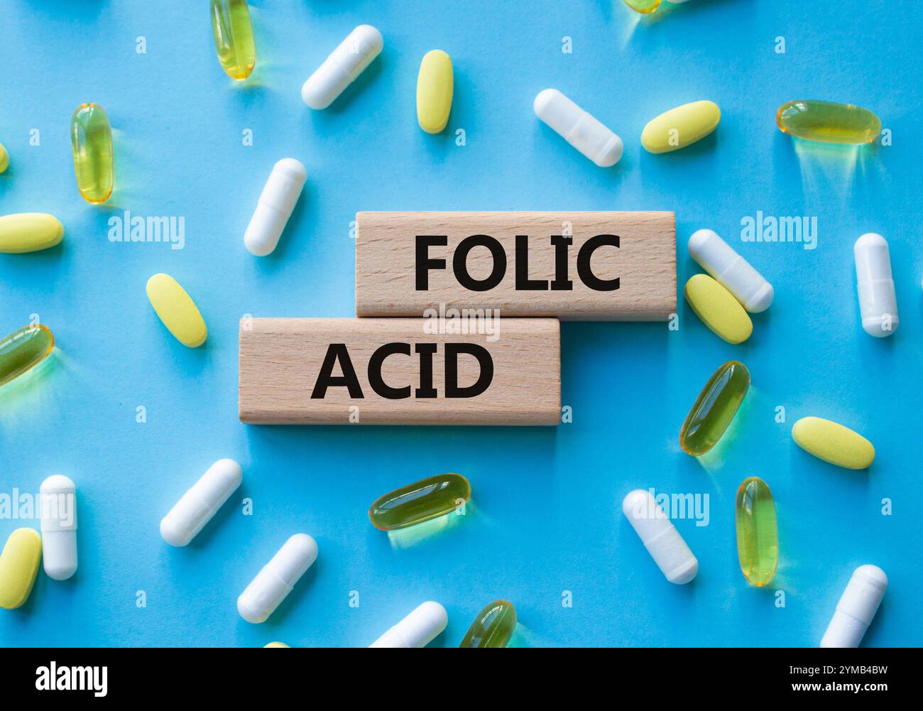 Folic acid symbol. Wooden blocks with words Folic acid. Beautiful blue ...