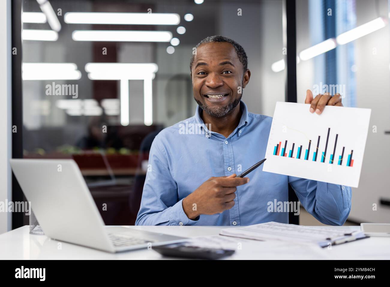 African American businessman presenting sales chart. Smiling, confident ...