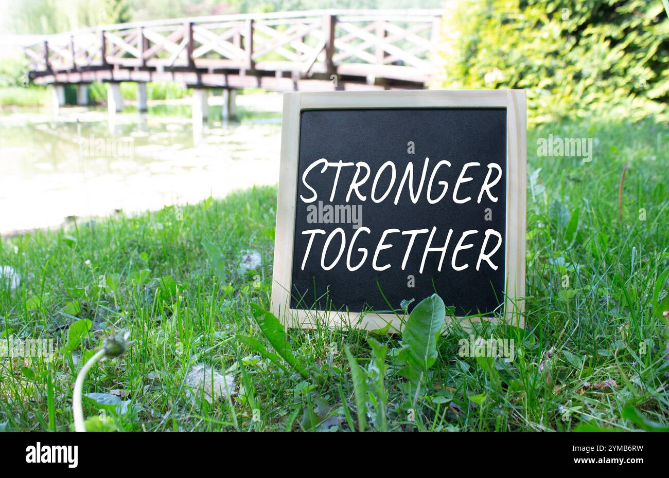 Stronger together symbol. Concept word Stronger together on black chalk ...