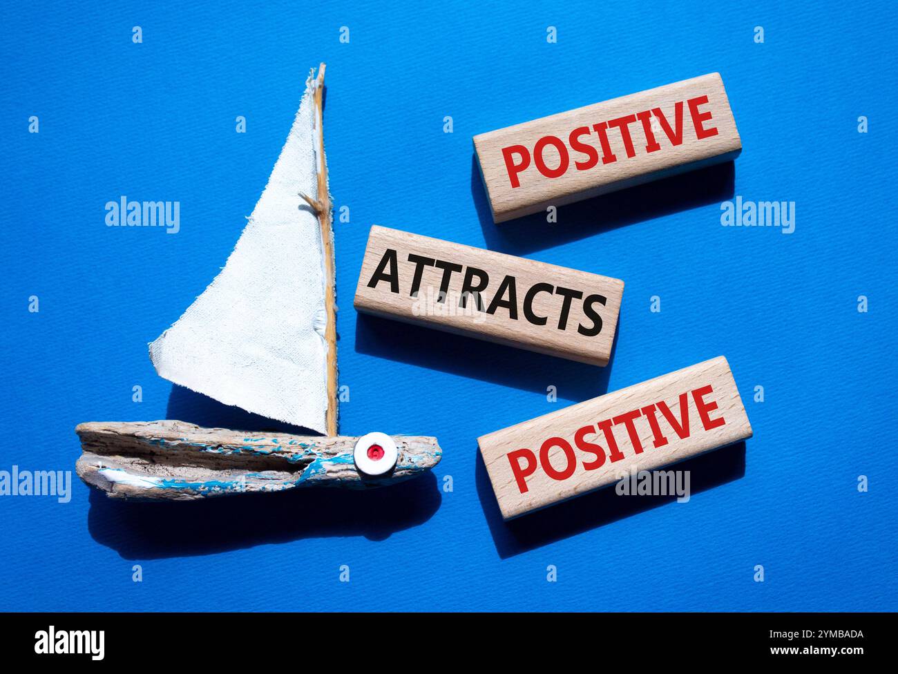 Positive attracts Positive symbol. Wooden blocks with words Positive ...