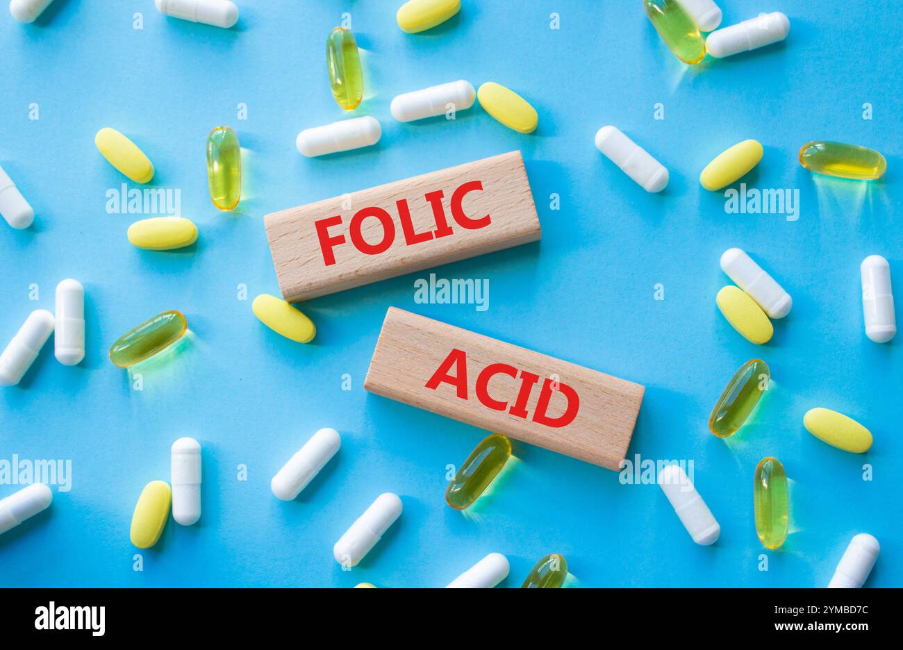 Folic acid symbol. Wooden blocks with words Folic acid. Beautiful blue ...