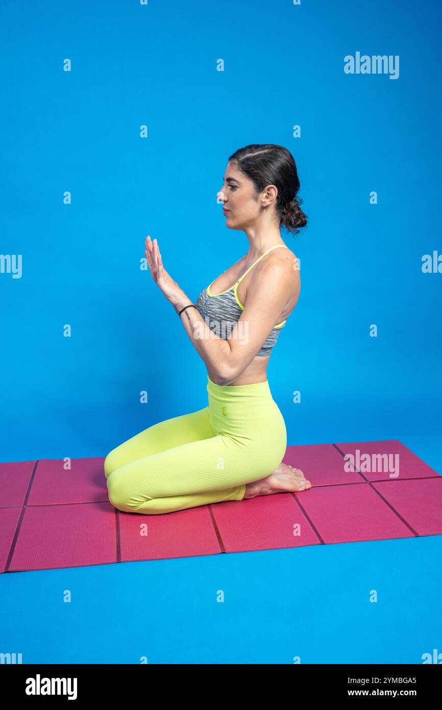 Yoga instructor practicing vajrapradama mudra, a gesture of unshakeable ...