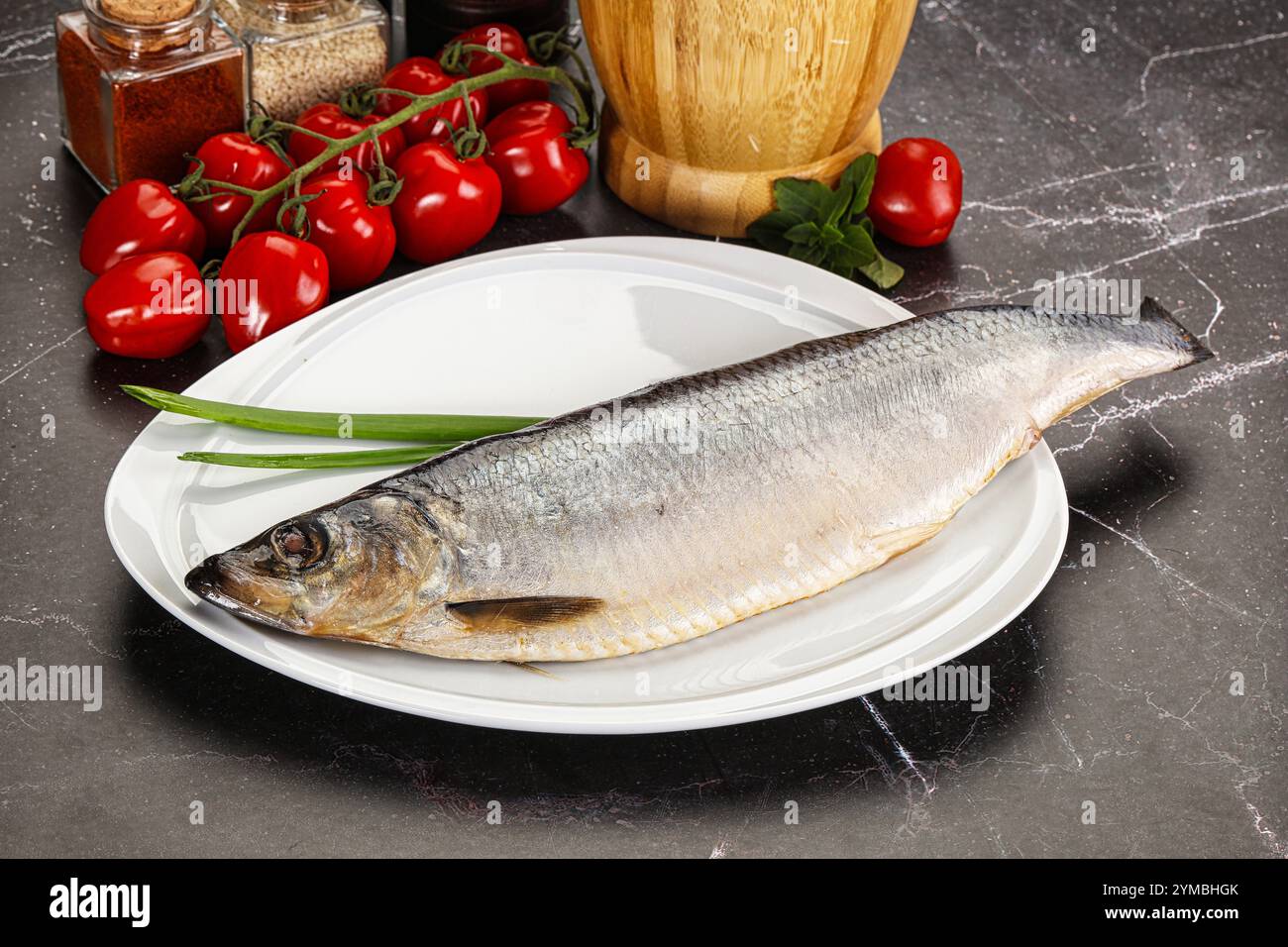 Whole raw salted herring fish in the plate Stock Photo - Alamy