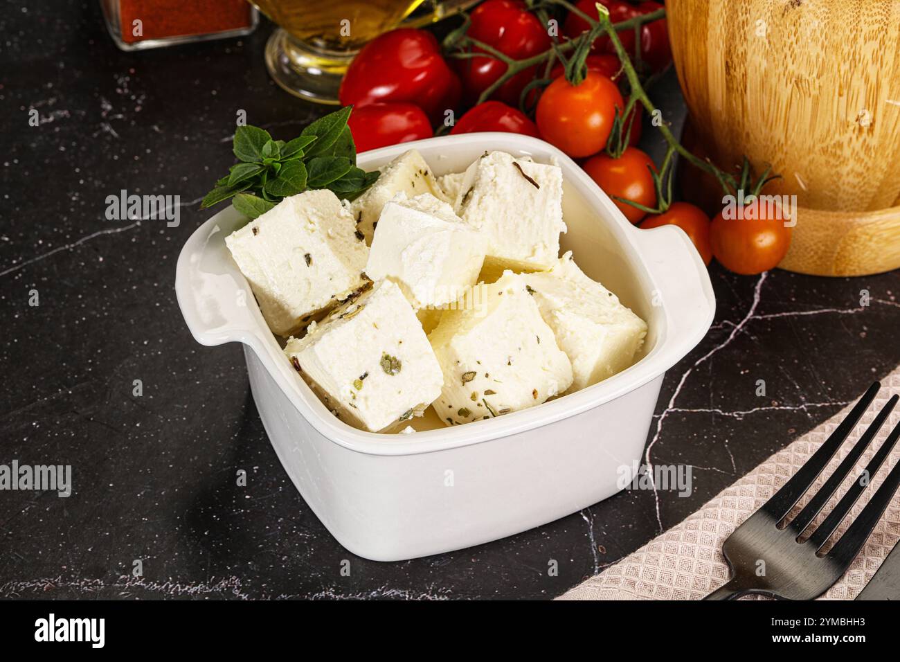 Greek traditional Feta cheese cubes with herbs and spices Stock Photo ...