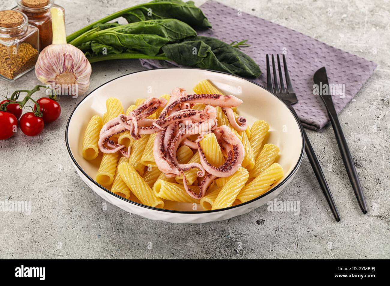 Italian cuisine - pasta tortiglioni with squid tentacles Stock Photo ...