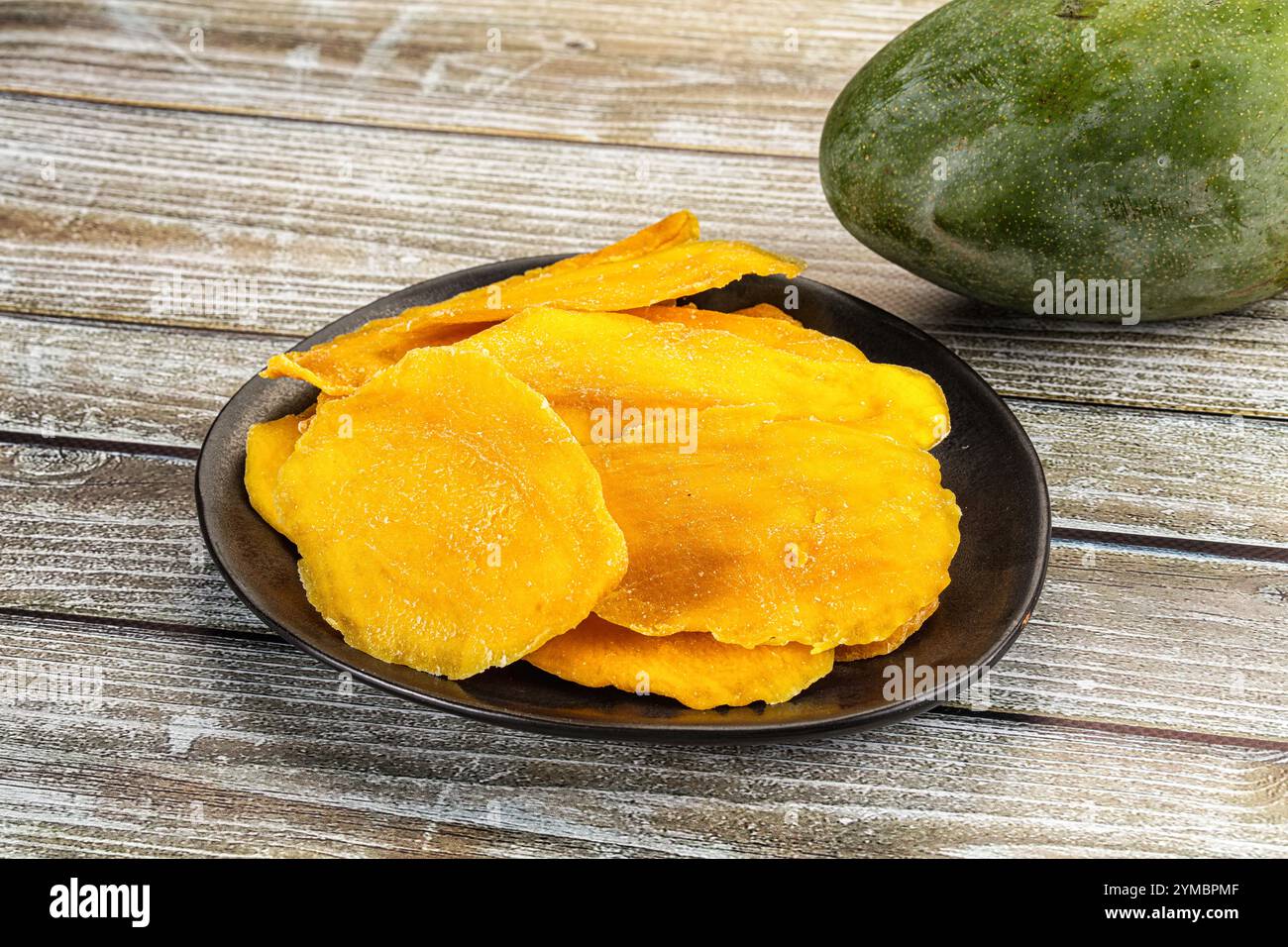 Dry sweet yellow mango snack in the plate Stock Photo - Alamy