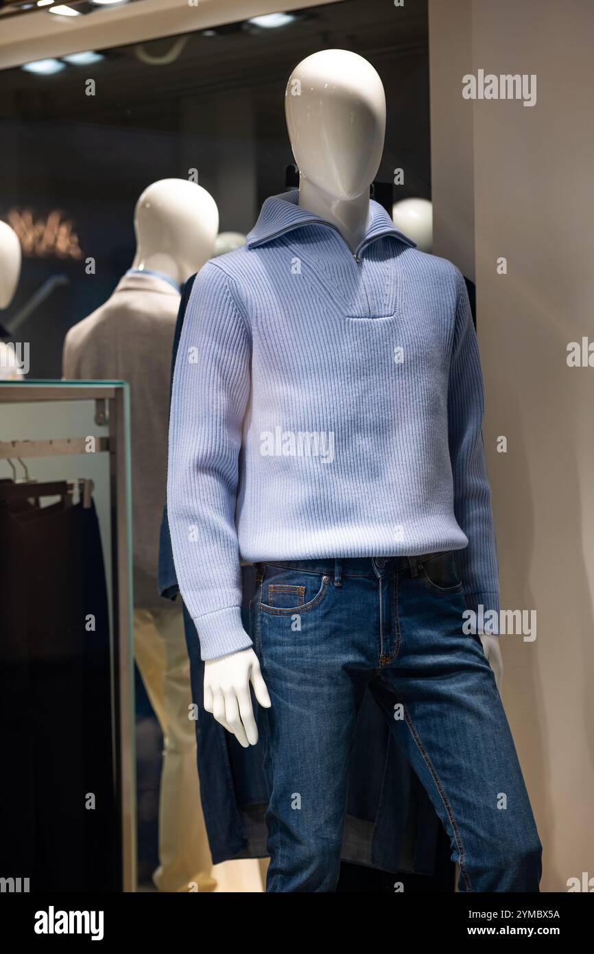 Male mannequin in store glass window display dressed casual autumn ...