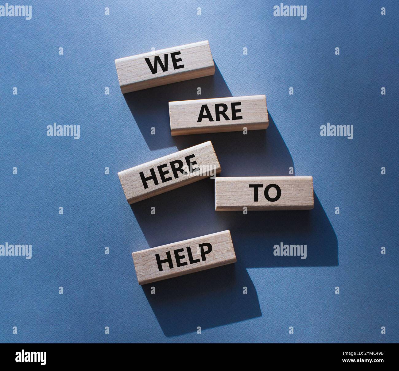 We are here to help symbol. Concept words we are here to help on wooden ...