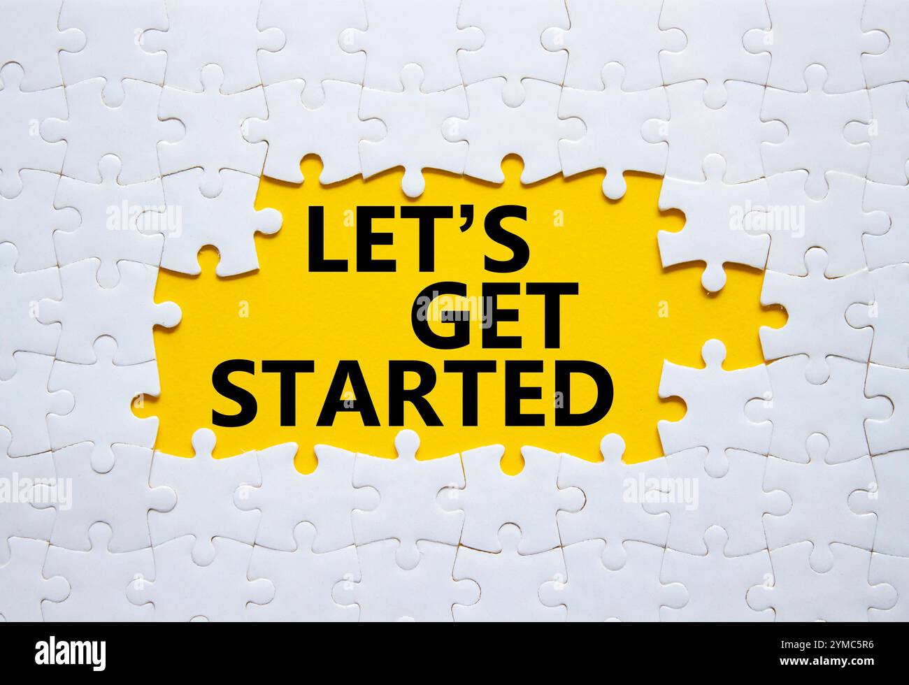 Lets get started symbol. Concept words Lets get started on white puzzle ...