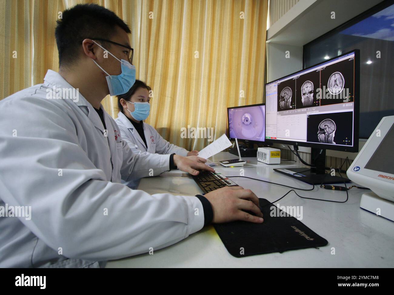 A medical worker looks at an MRI image in Handan, Hebei province, China ...