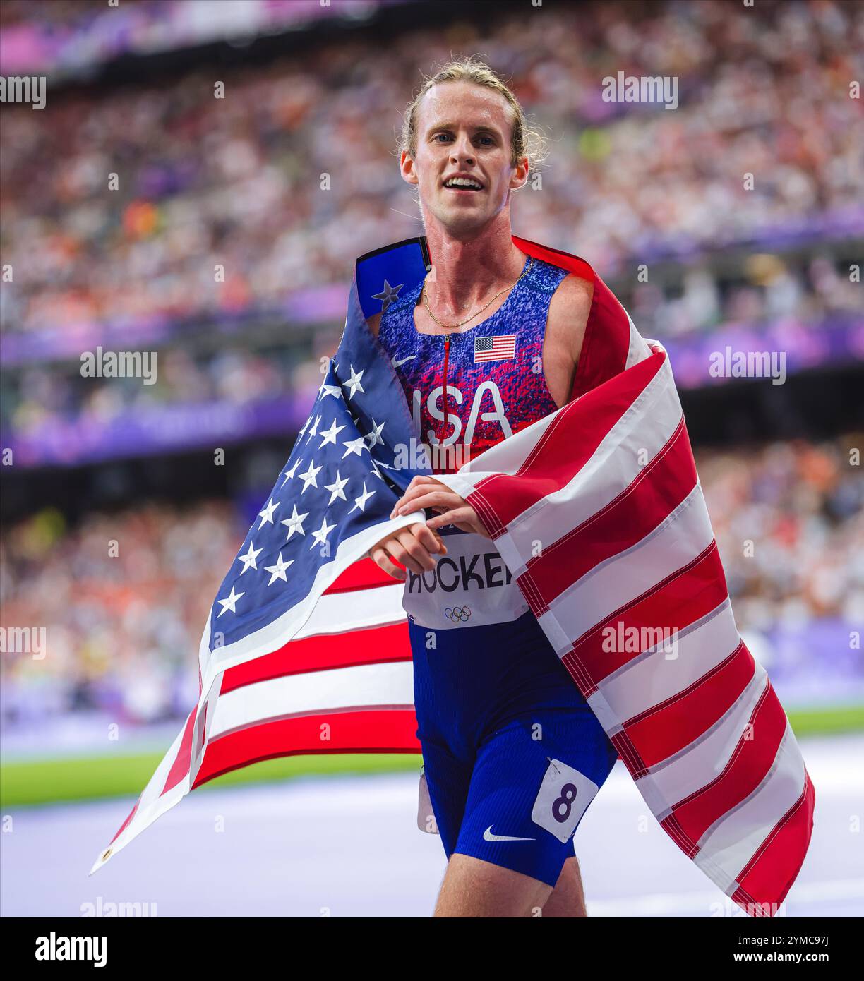 Cole Hocker celebrating her medal with her country's flag at the Paris ...