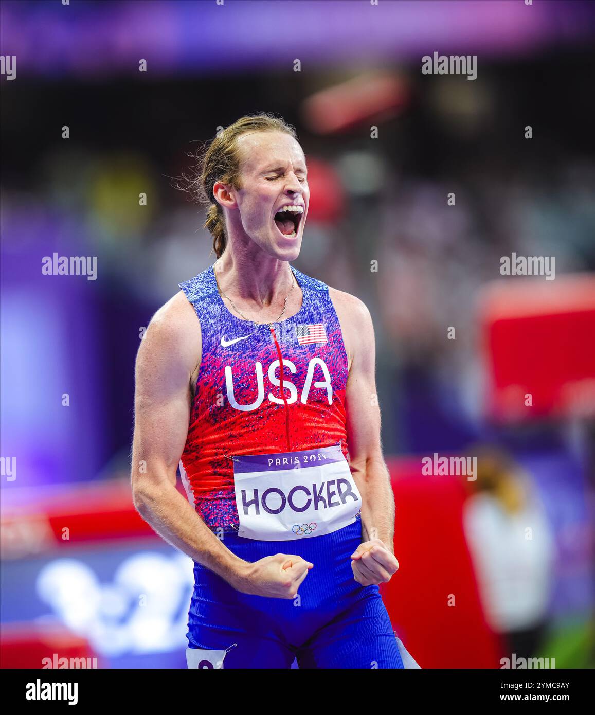Cole Hocker celebrating her medal with her country's flag at the Paris ...