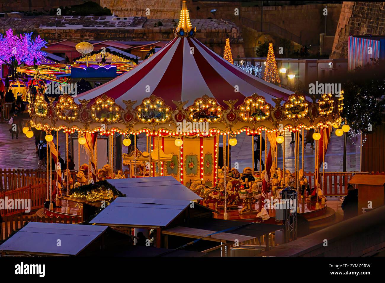 Illuminated Carousel at Festive Night Christmas market Stock Photo - Alamy