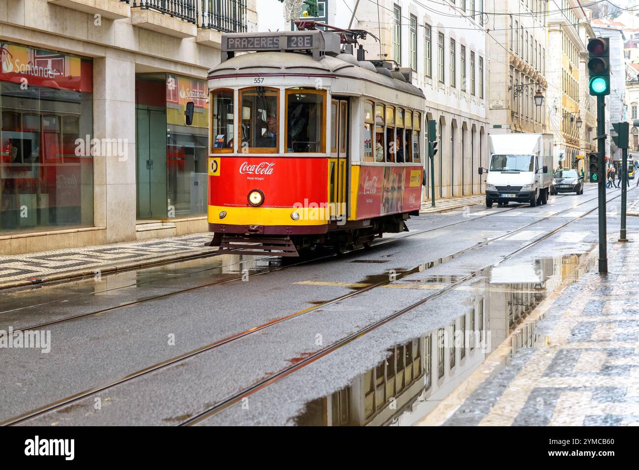 A traditional tram old vehicle drives on a city street in the old town ...