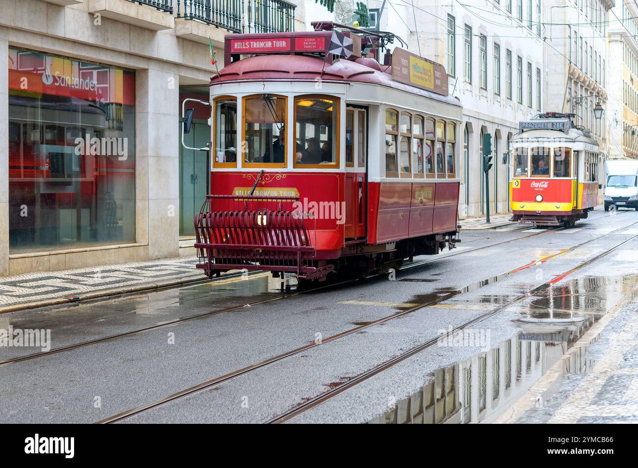A traditional tram old vehicle drives on a city street in the old town ...