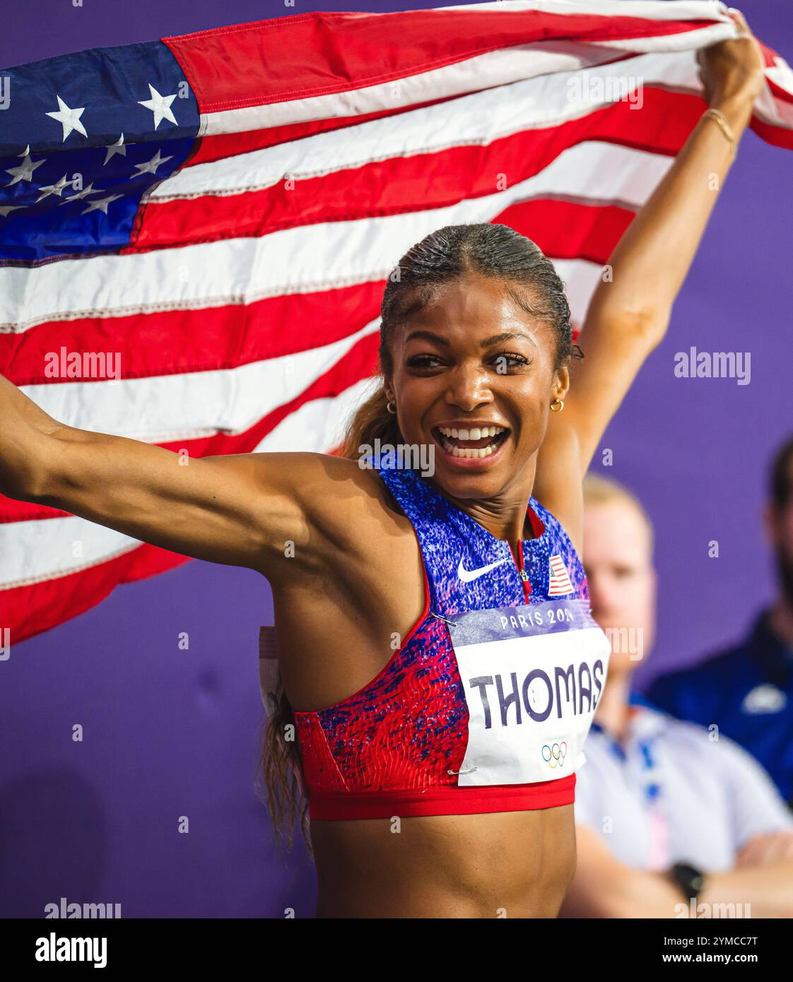 Gabrielle Thomas celebrating with her country's flag in the 200 meters ...