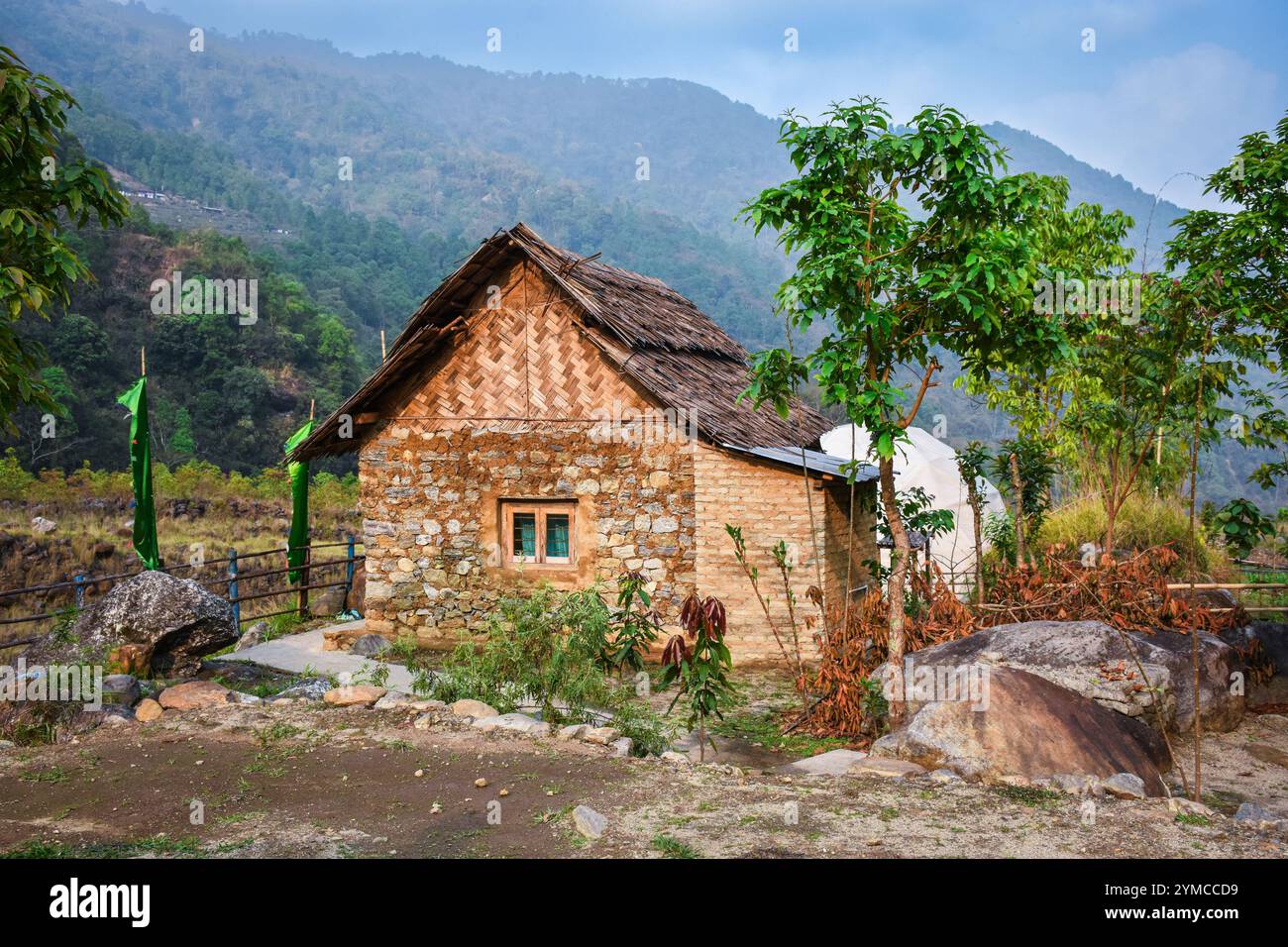 Stone cottage with thatch roof,Himalayan Mountain ridges Stock Photo ...
