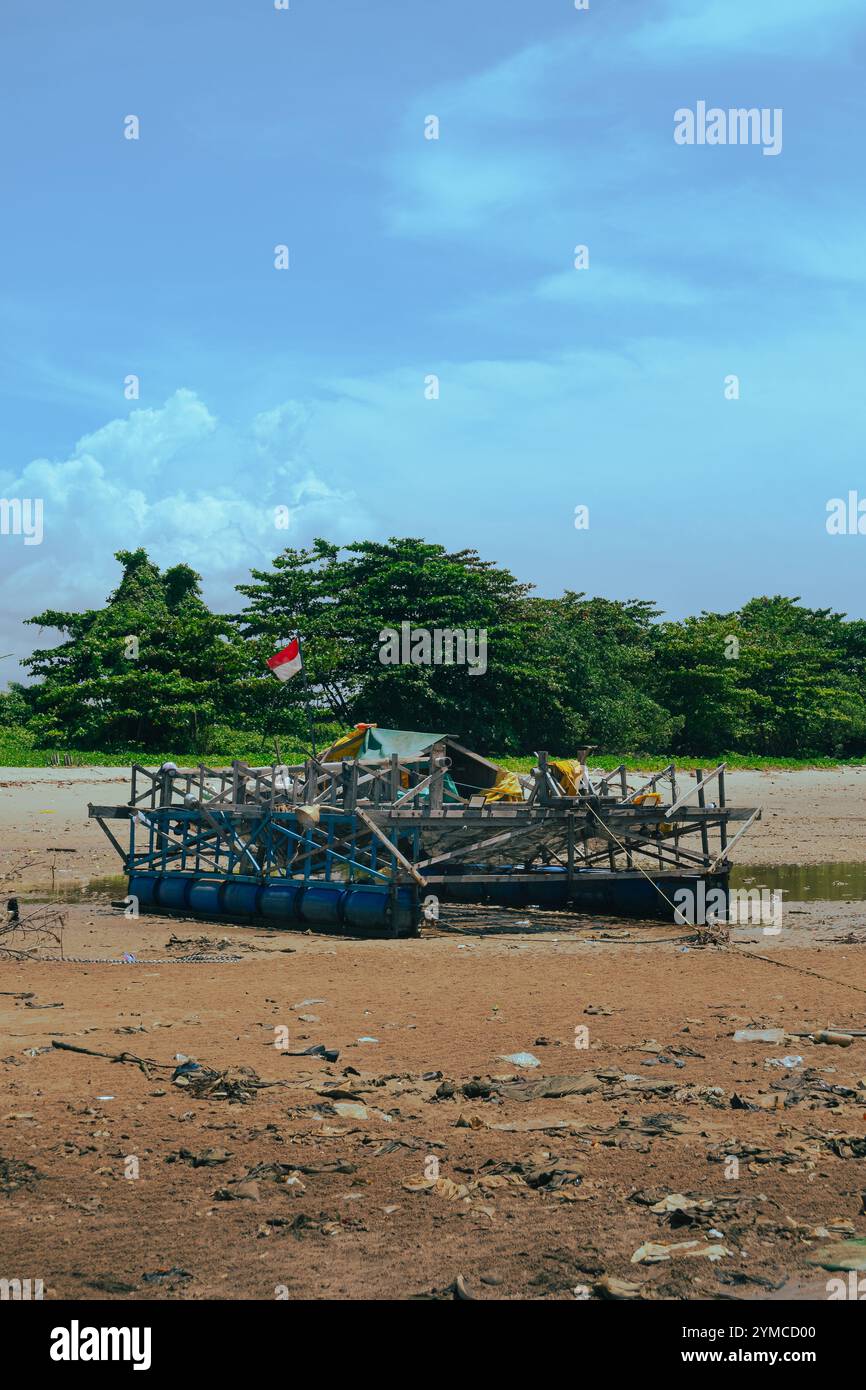 A modified fishing boat that looks like a fishpond is stranded on the beach in Balikpapan due to ...