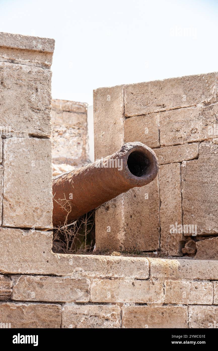 Pointing towards the sea through a crenel in the rampart of the ...