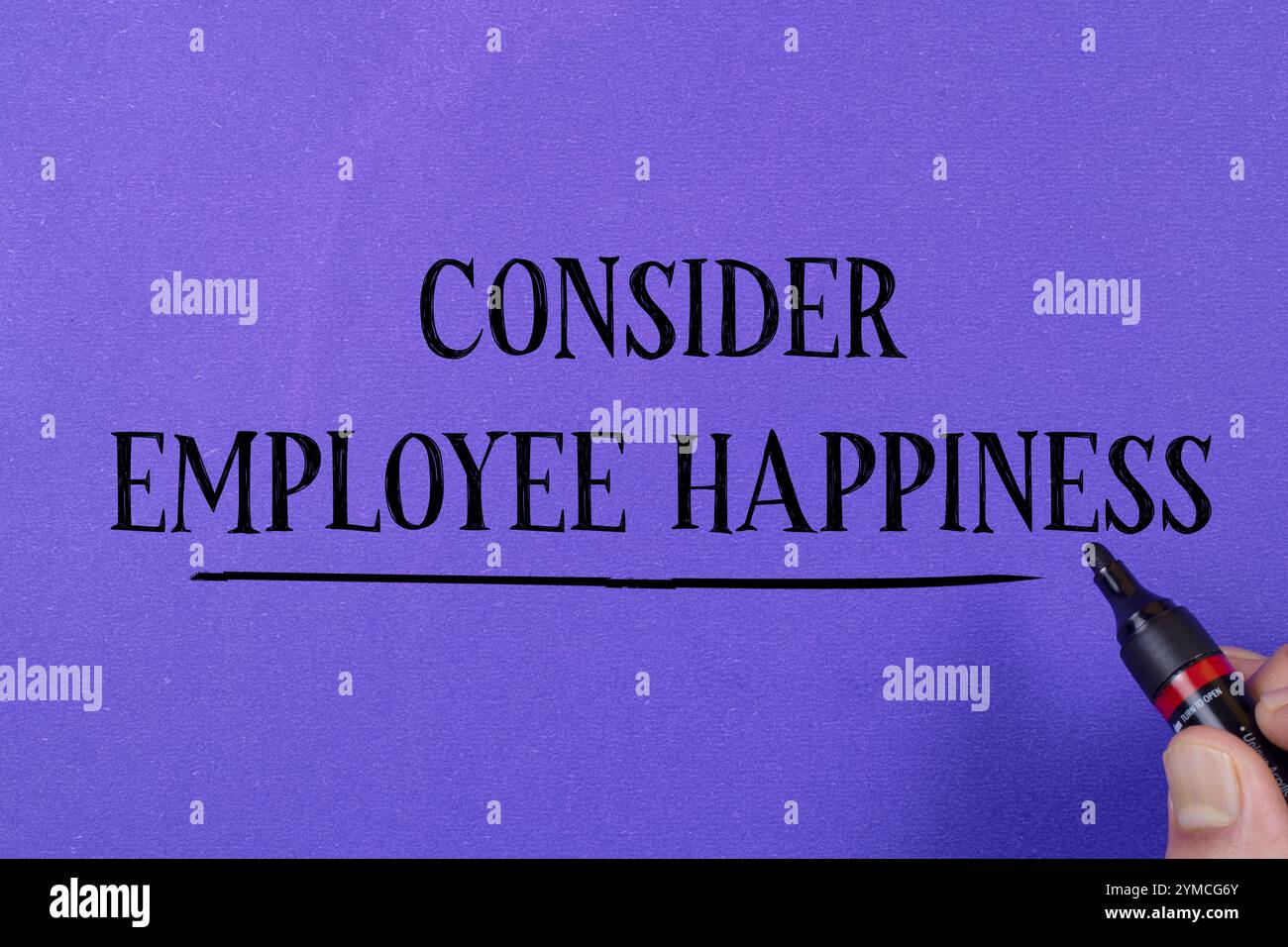 Hand writing the message Consider Employee Happiness on a Purple ...