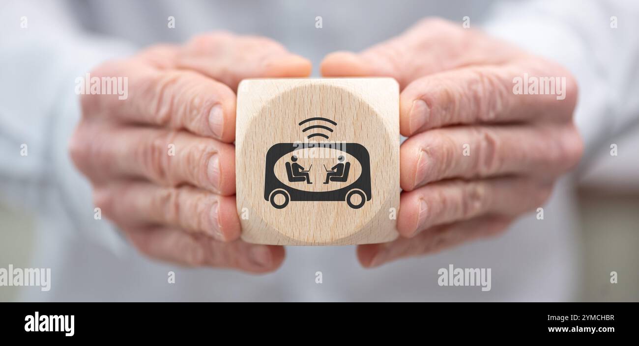 Hand holding a wooden cube with symbol of self-driving car concept ...