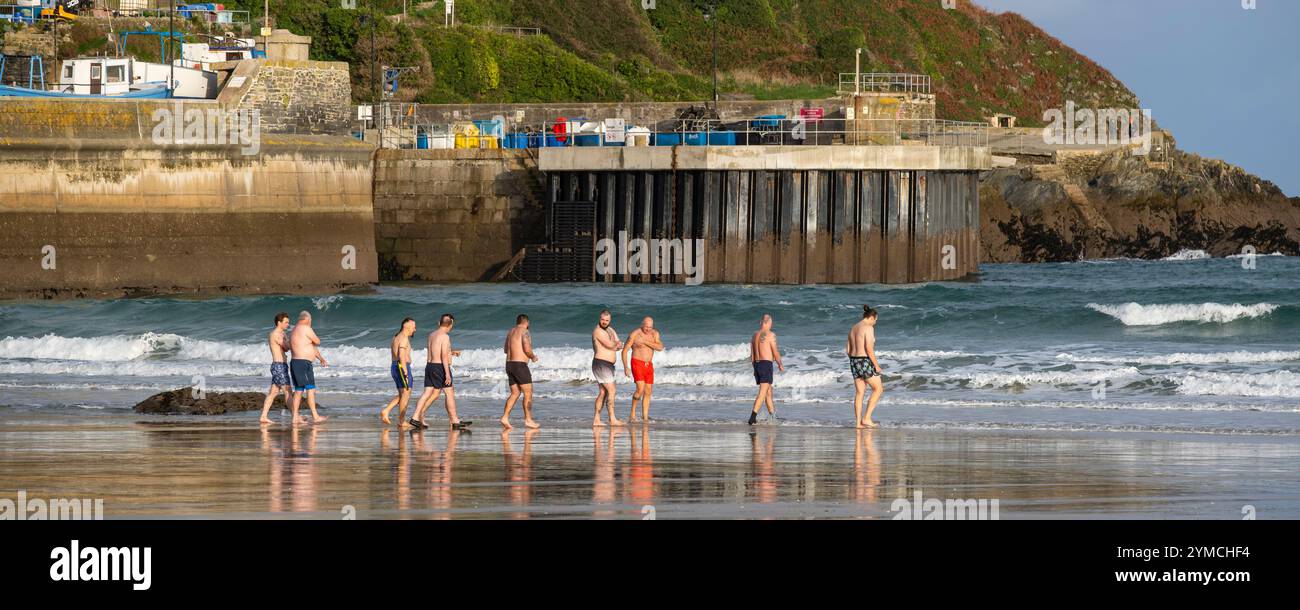 A panoramic image of a group of male cold water swimmers walking into ...
