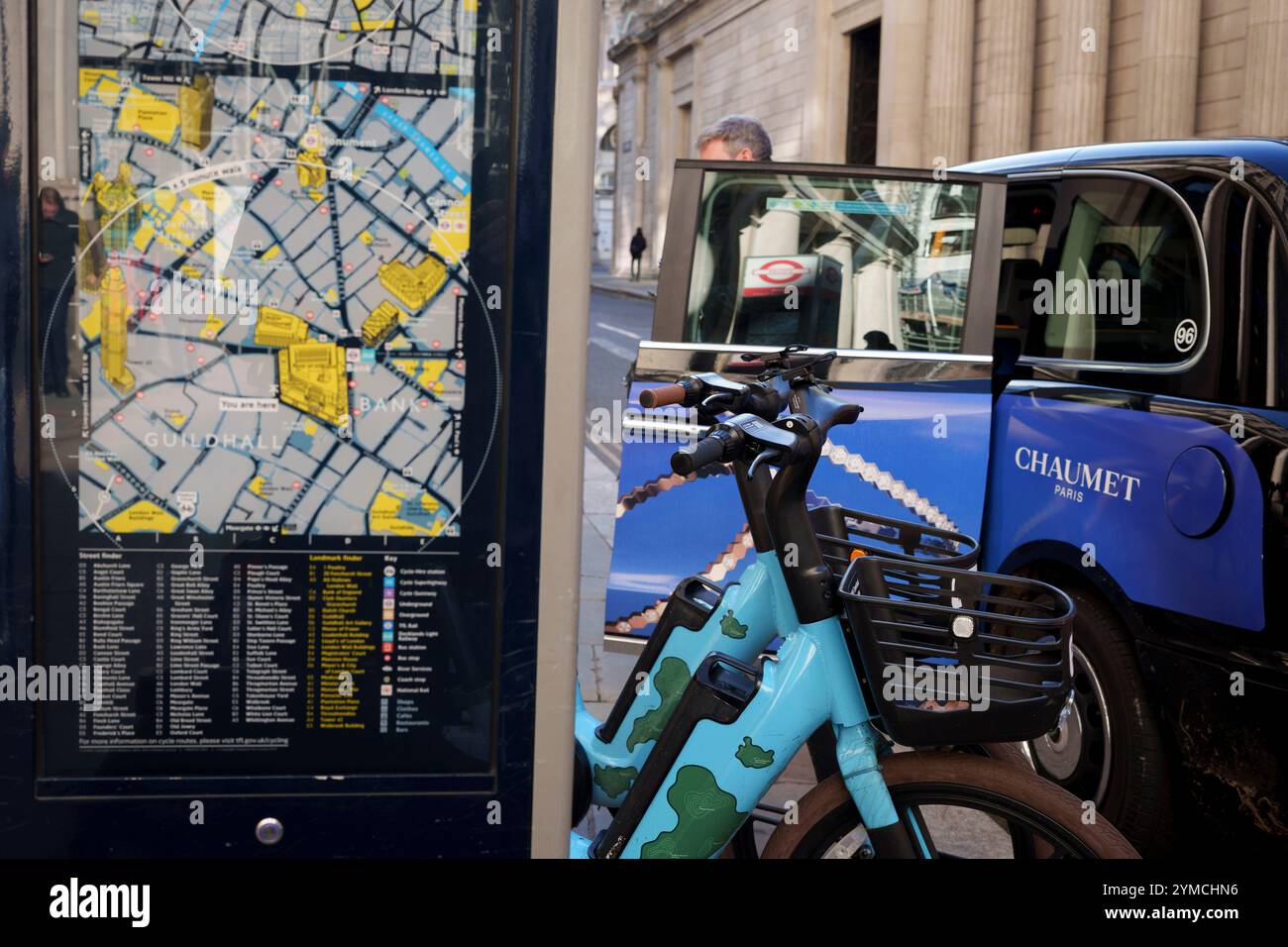A businesman exits a taxi beneath the architecture of the Bank of ...