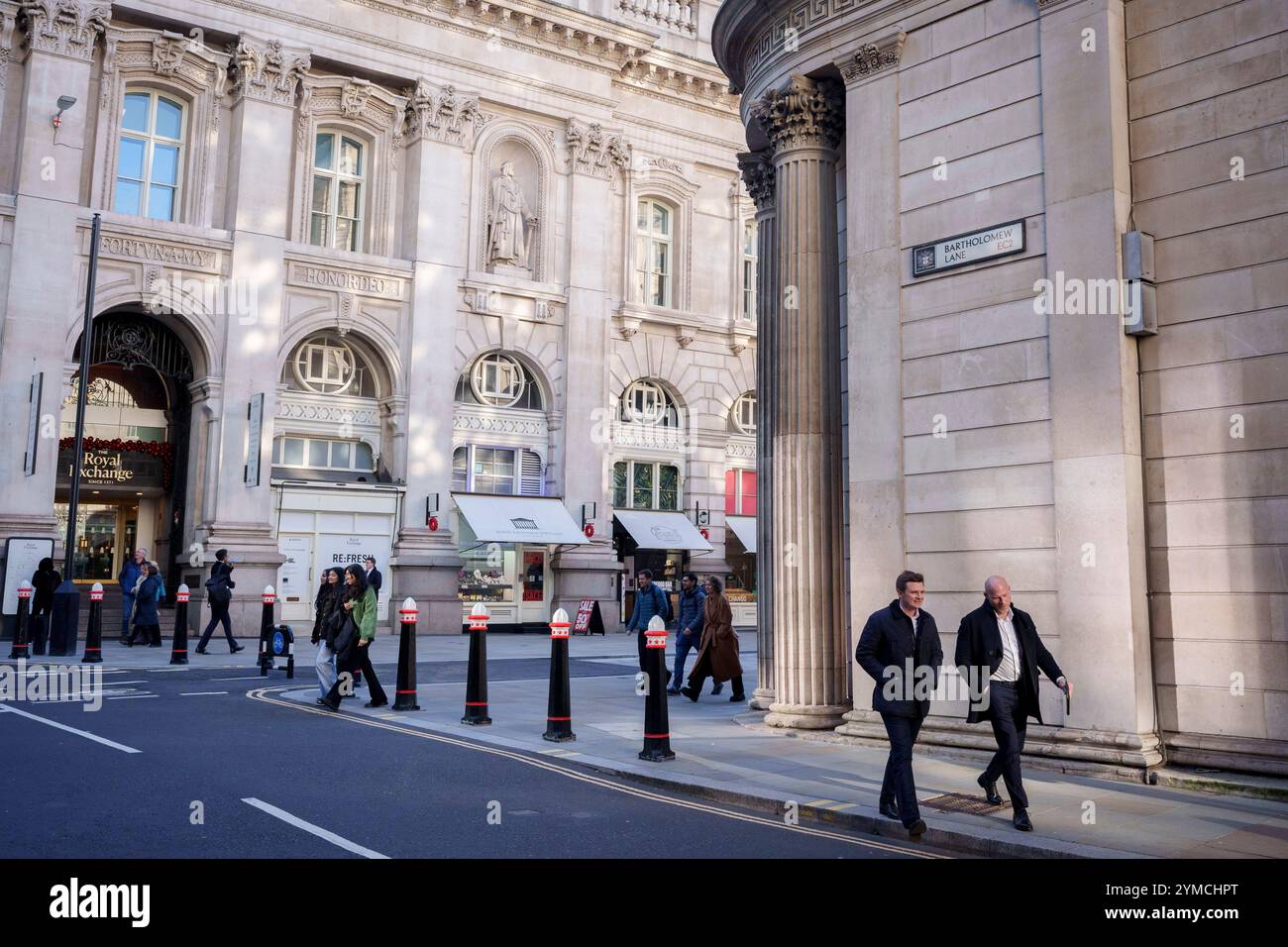 City workers walk across the corner of Threadneedle Street and ...