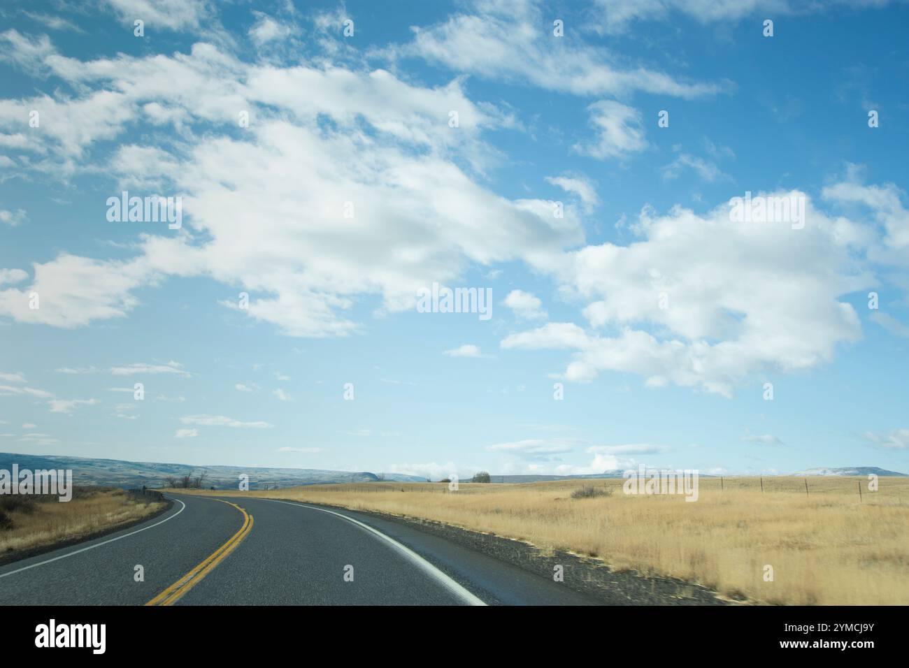 Highway 95 crossing grassy field Stock Photo - Alamy