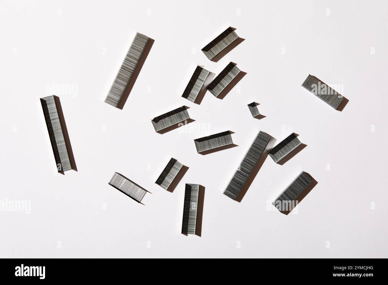 Overhead view of staples on white background Stock Photo - Alamy