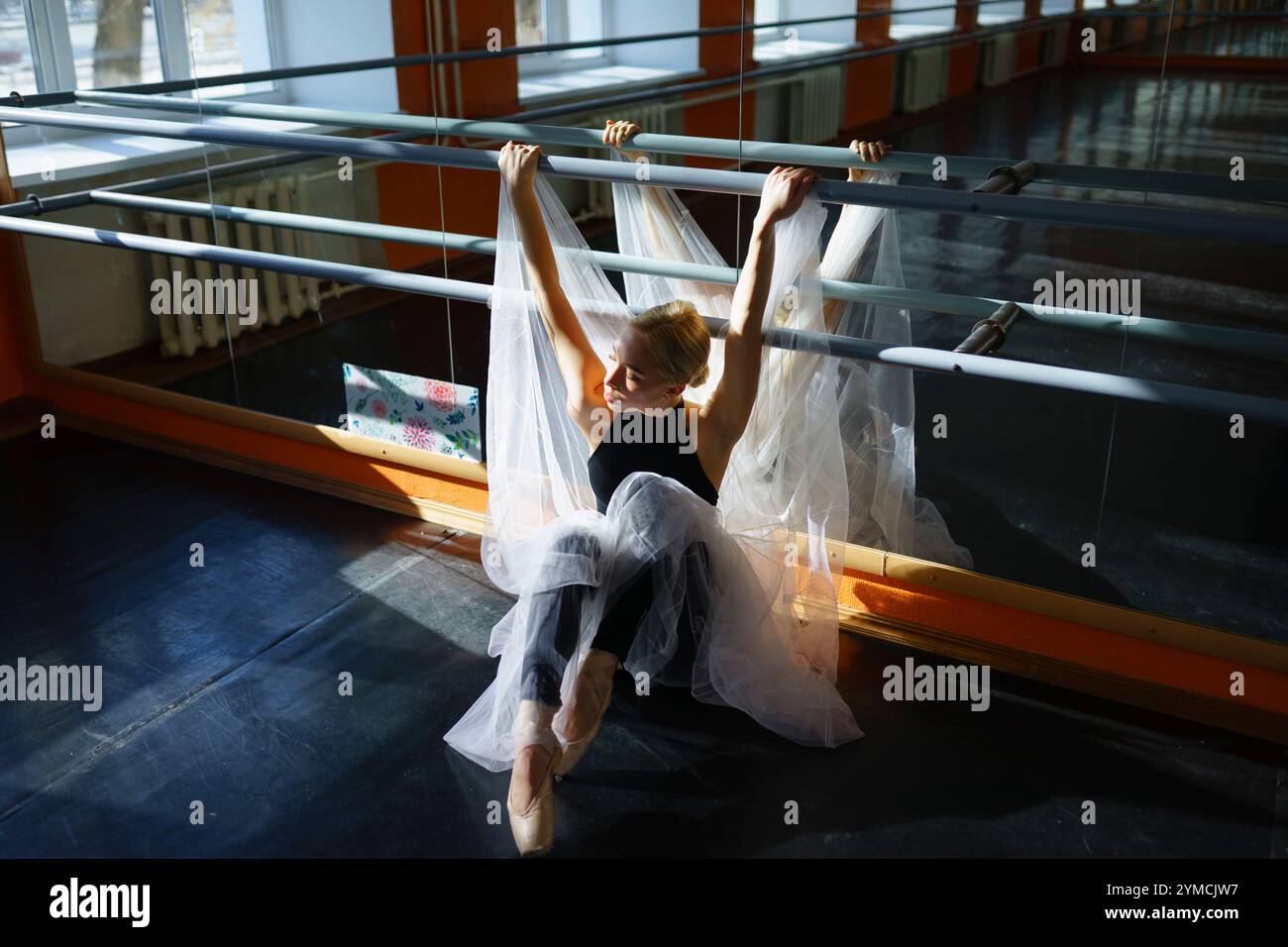 Portrait of ballerina sitting in ballet studio Stock Photo - Alamy