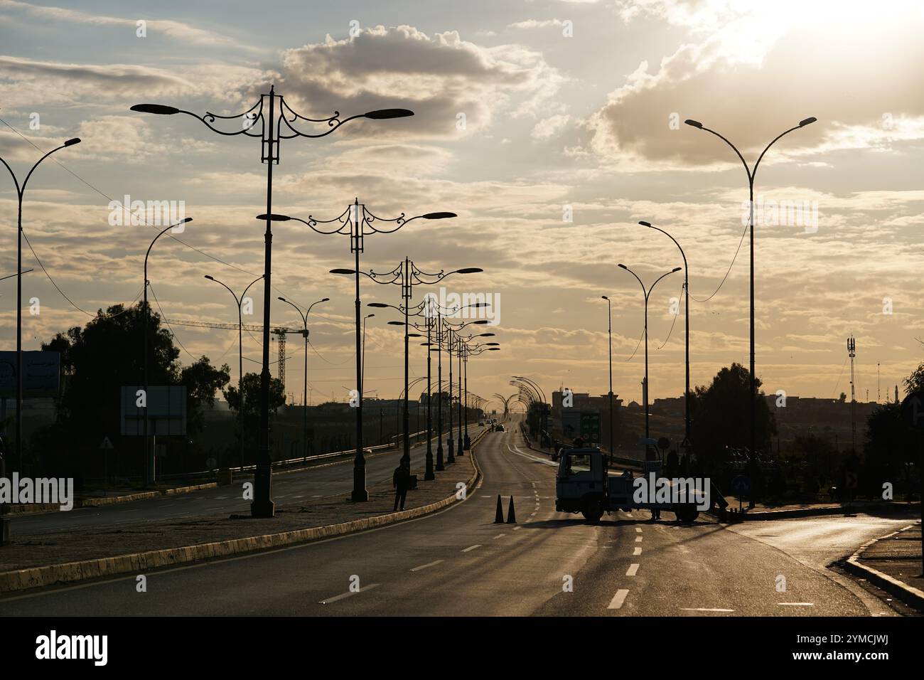 Mosul, Iraq. 20th Nov, 2024. A silhouette view of an empty road in the ...