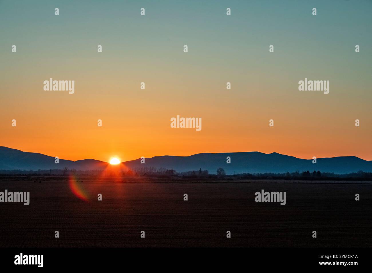 Sun setting behind hills near Sun Valley Stock Photo - Alamy