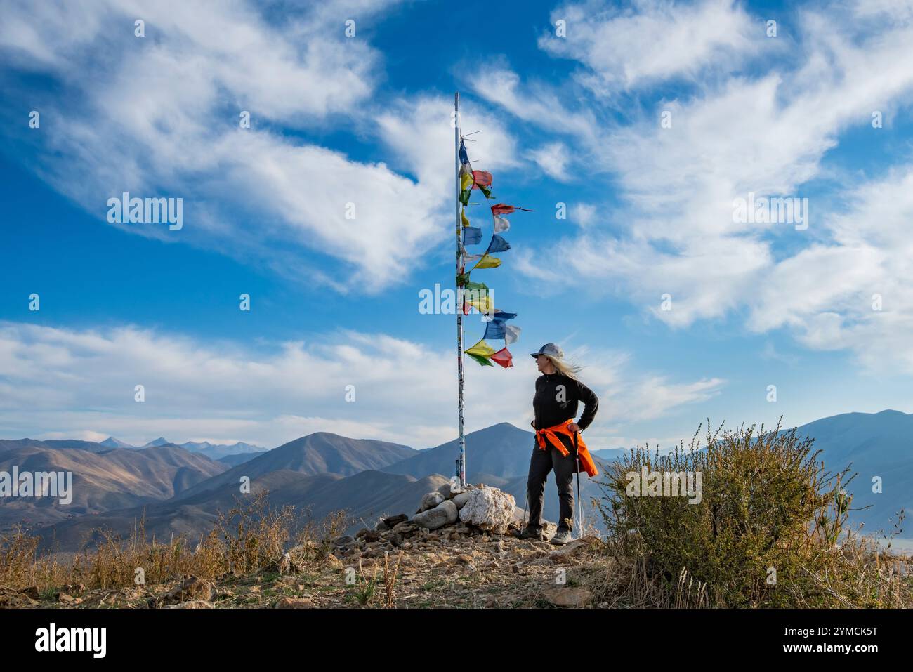 Female hiker atop Carbonate Mountain at prayer flags pole Stock Photo ...
