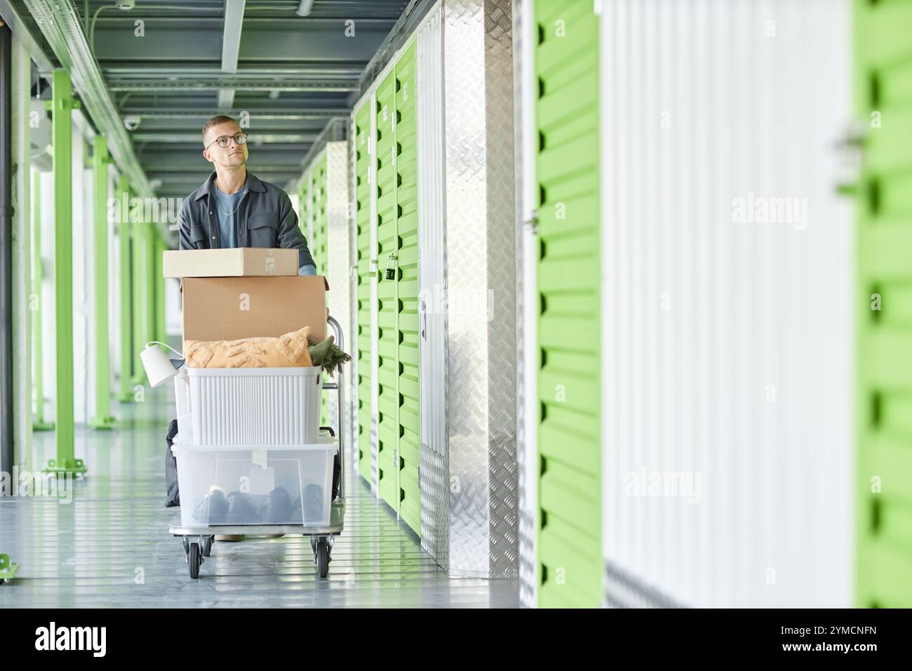 Man pushing cart loaded items hi-res stock photography and images - Alamy