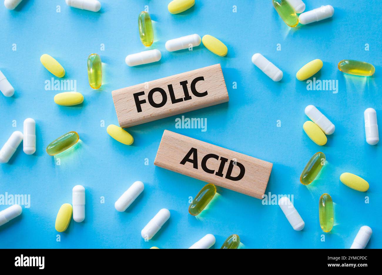Folic acid symbol. Wooden blocks with words Folic acid. Beautiful blue ...