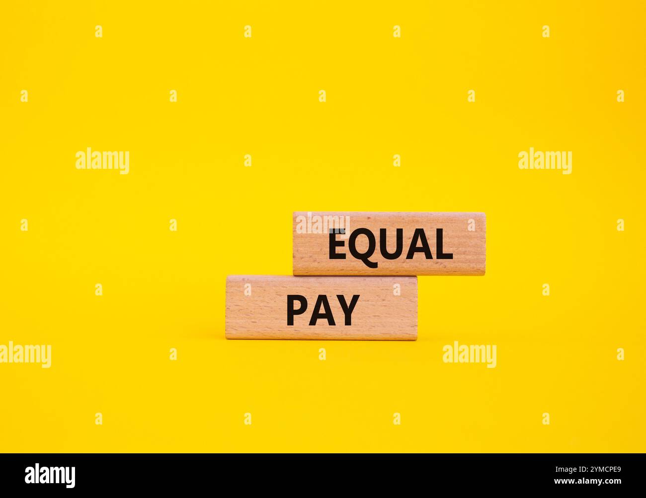 Equal Pay symbol. Wooden blocks with words Equal Pay. Beautiful yellow ...