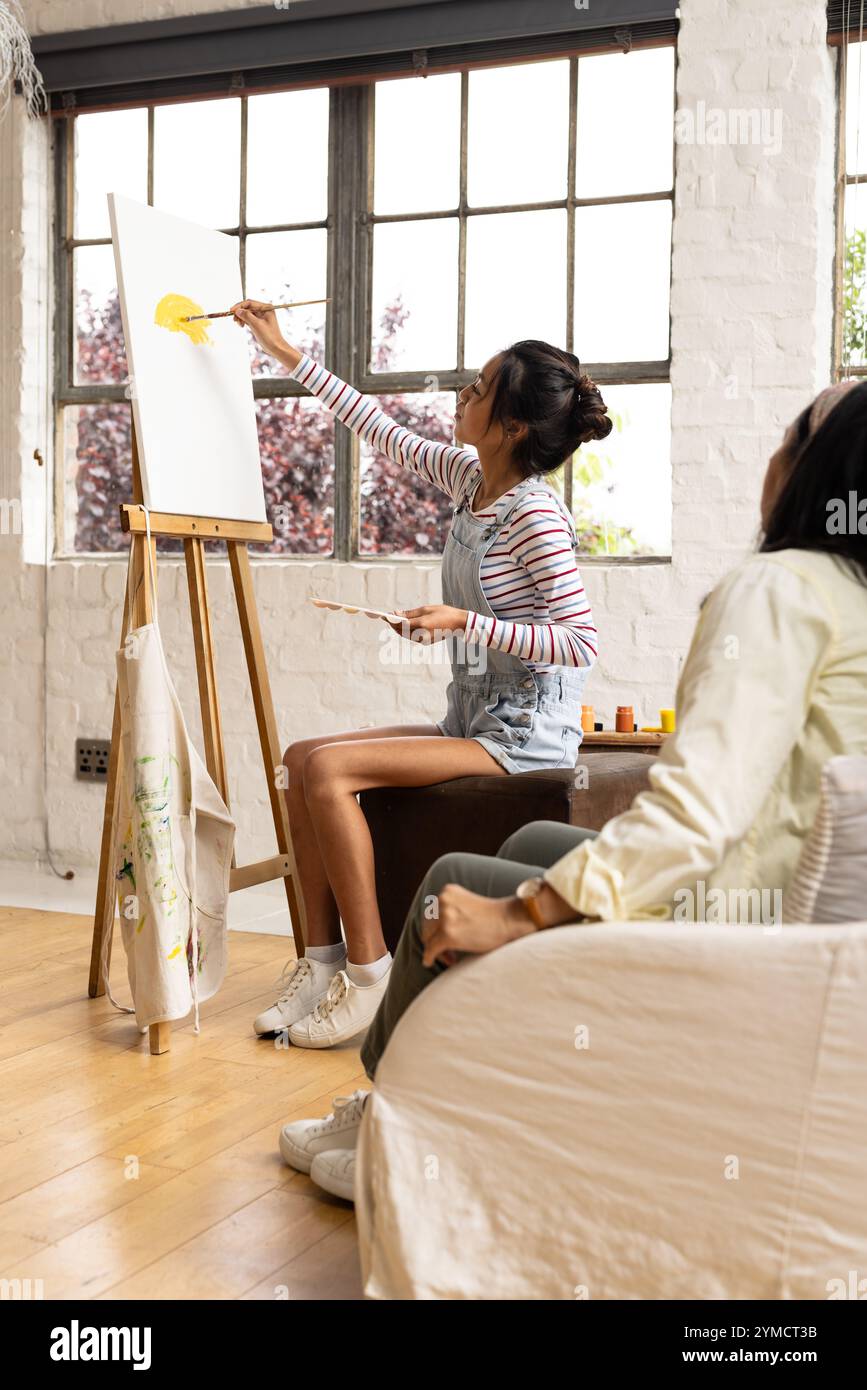 asian female teenager painting on canvas at home, enjoying creative time with family Stock Photo ...