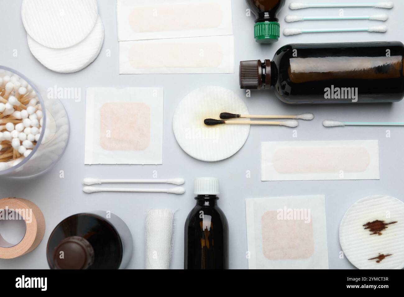 Topical iodine and other first aid kit components on light grey ...