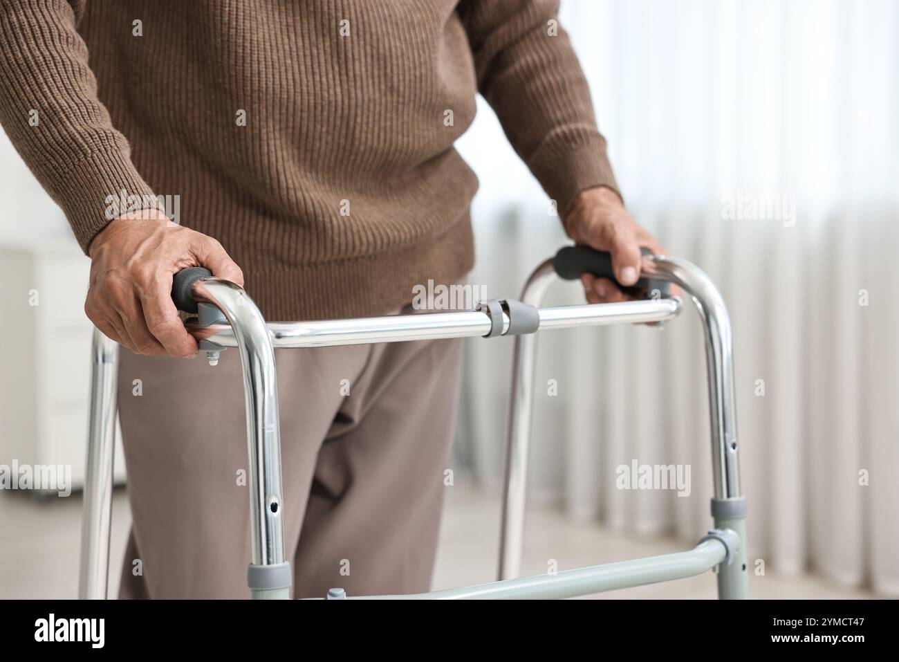 Using walking frame using walking aid hi-res stock photography and ...